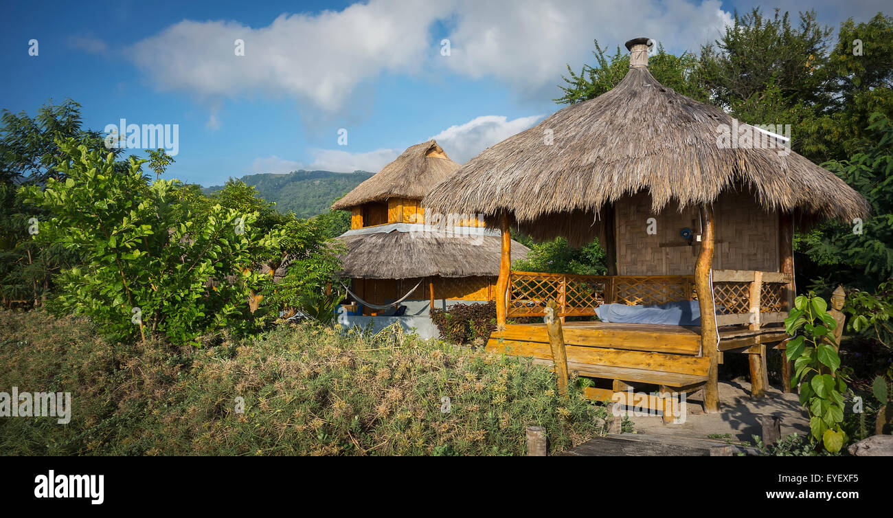 Structure with thatch roof for sun shade at beach resort; Atauro Island ...
