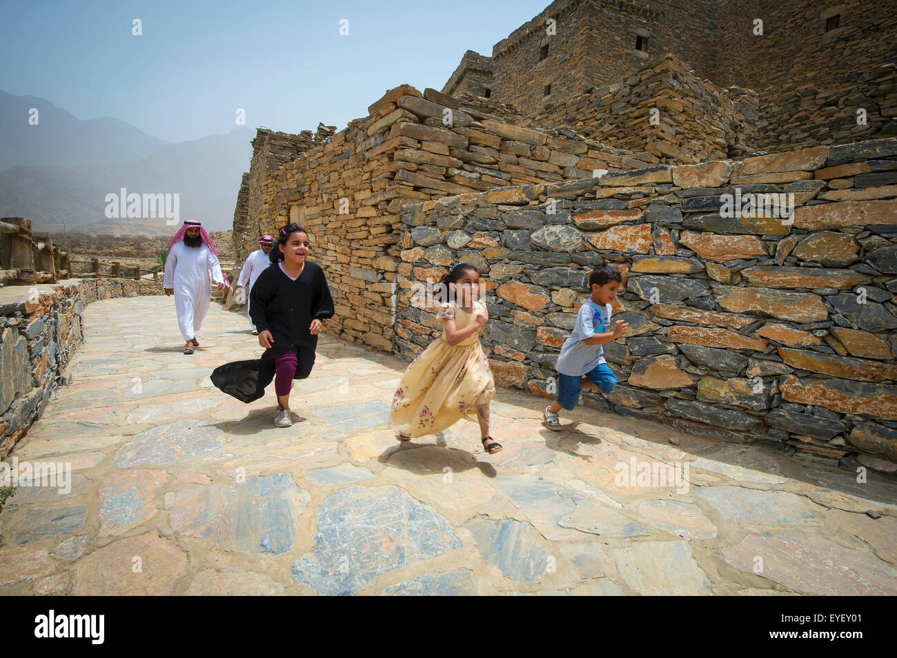 Children running along fortress wall; Taif, Saudi Arabia Stock Photo ...
