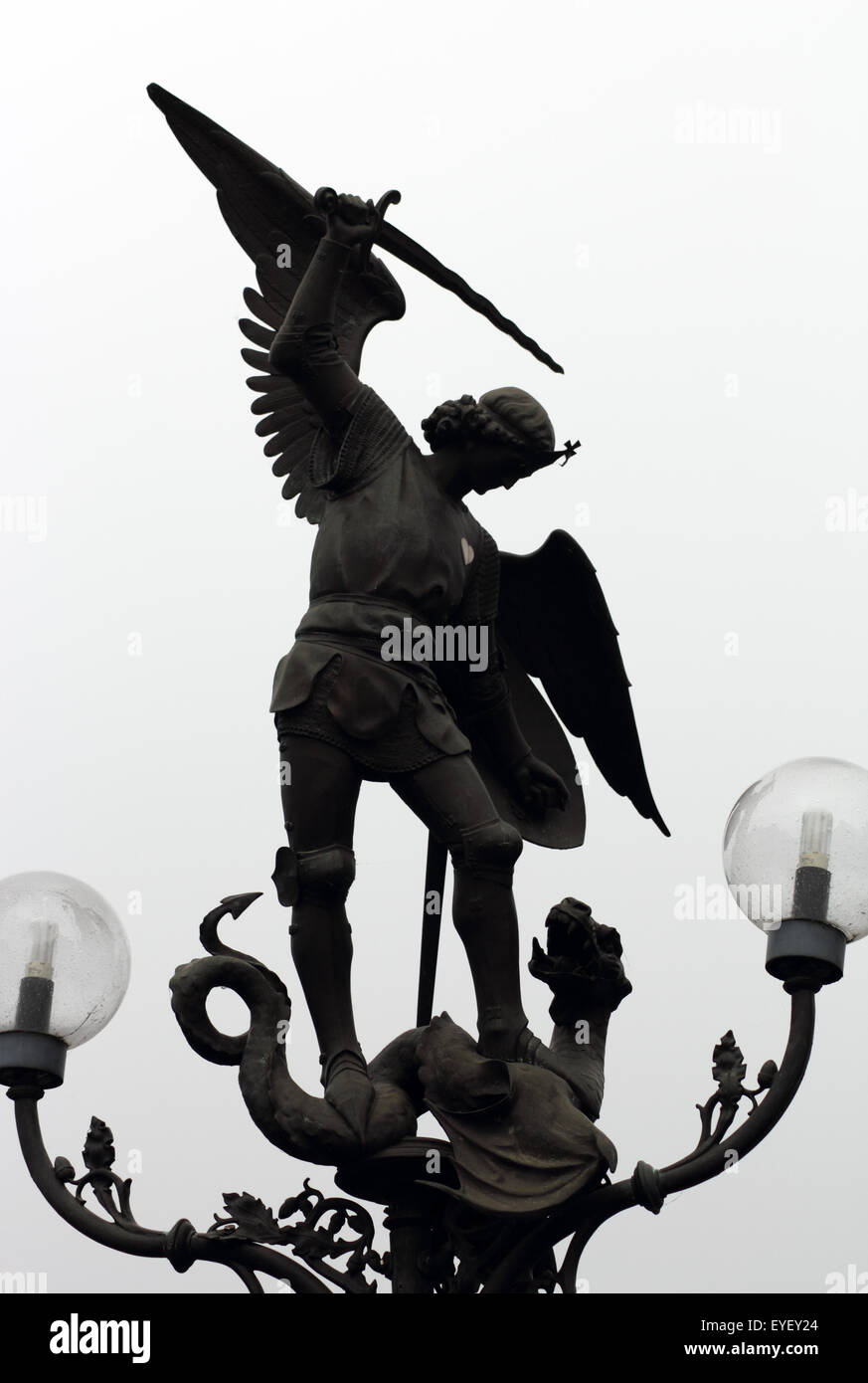 Statue in silhouette of Archangel Michael slaying Satan as a dragon, St ...
