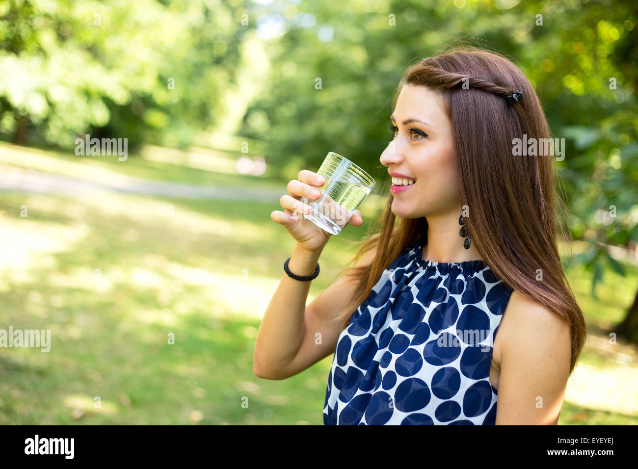 young woman drinking a glass of water outdoors Stock Photo - Alamy