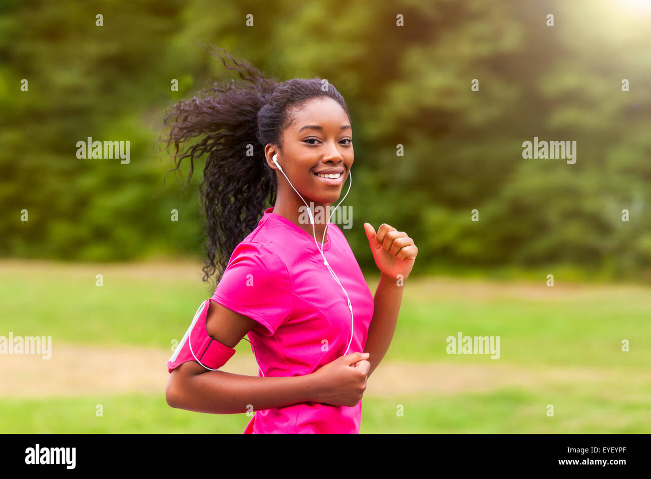 African american woman runner jogging outdoors - Fitness, people and ...