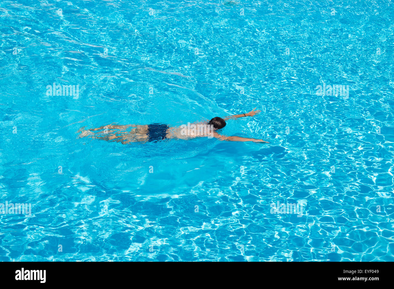 Man swimming in the pool alone on a sunny day Stock Photo - Alamy