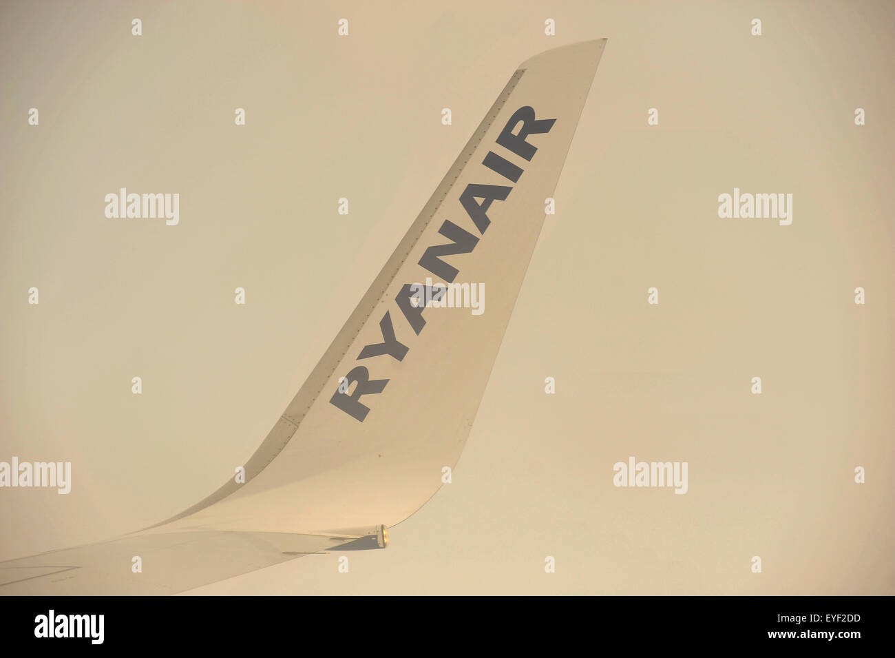 A Ryan Air wingtip viewed through the window of a Ryan Air flight fro ...