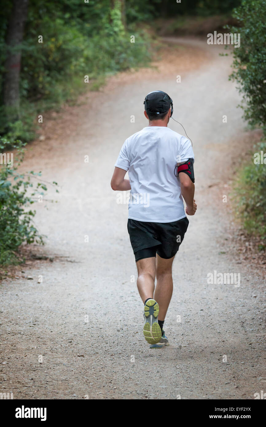 Young runner running in the forest Stock Photo - Alamy