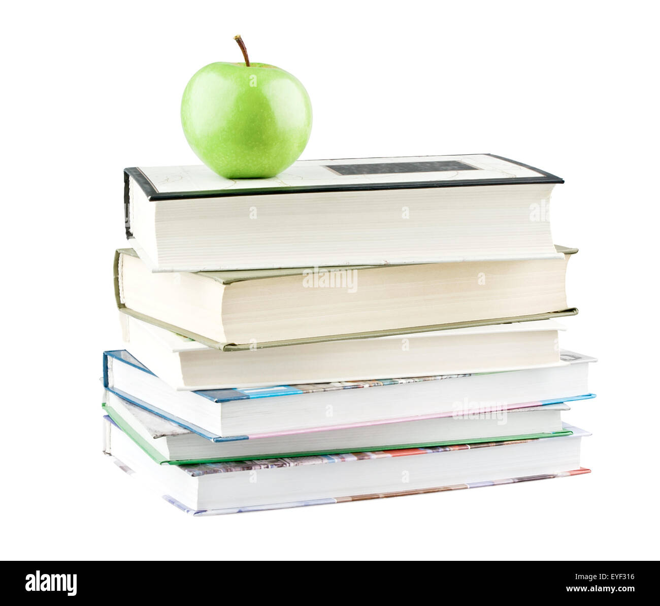 Green apple on textbooks on white background Stock Photo - Alamy