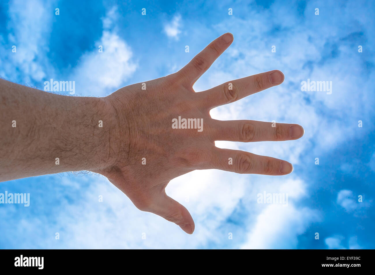 Hand against sky Stock Photo - Alamy