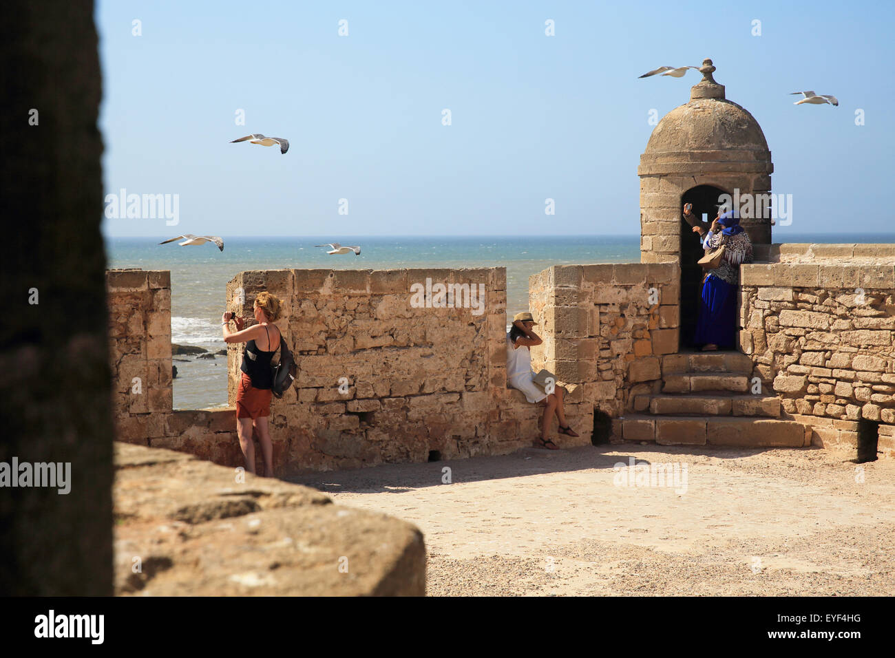 Tourists visiting the fortified tower in the Skala de la Ville in ...
