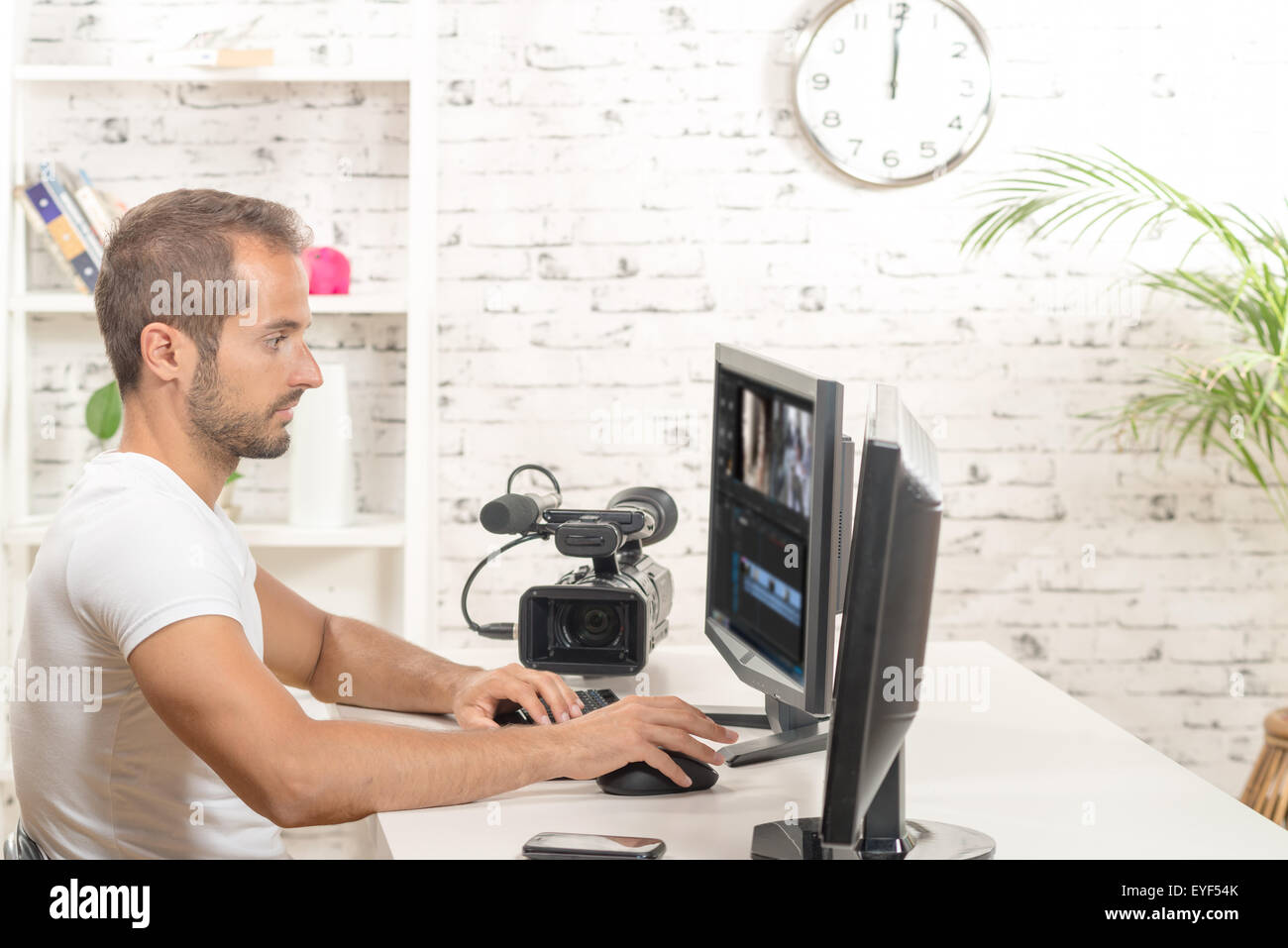 video editor with computer and professionnal video camera Stock Photo ...