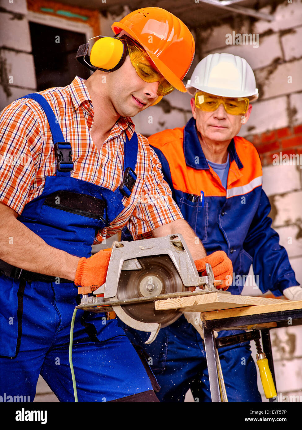 People in builder helmet Stock Photo - Alamy