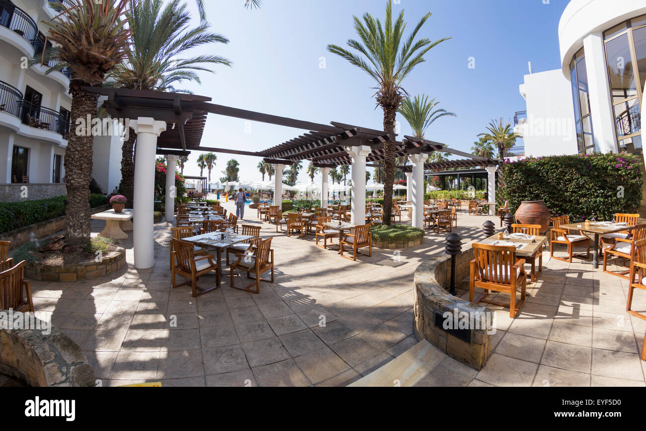 Seating on a patio with palm trees; Paphos, Cyprus Stock Photo - Alamy