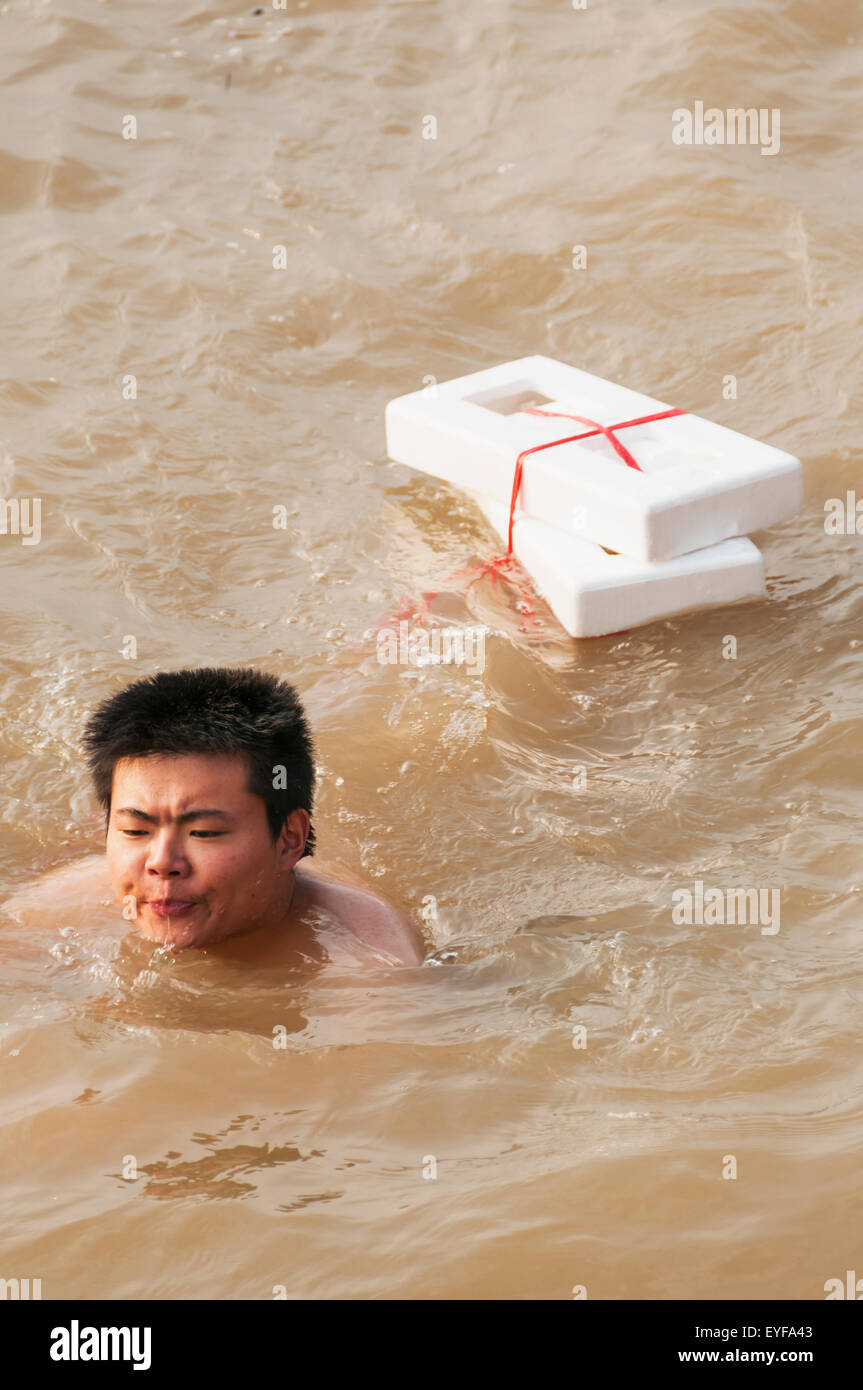 Man swimming in Yangtze river with a unique handmade float; Wuhan ...