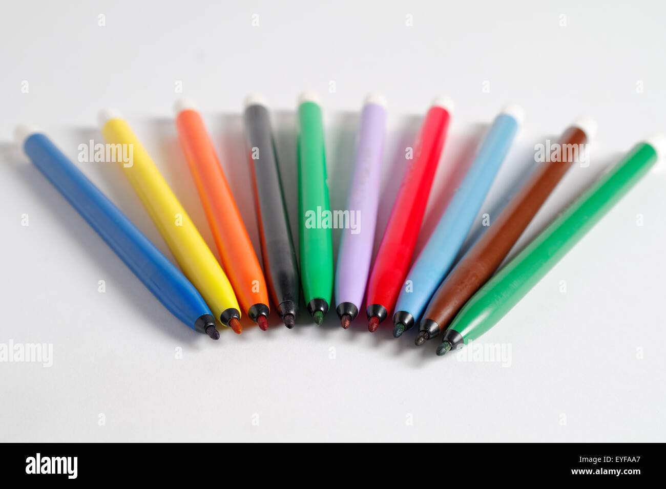 opened colorful markers on a white background Stock Photo - Alamy