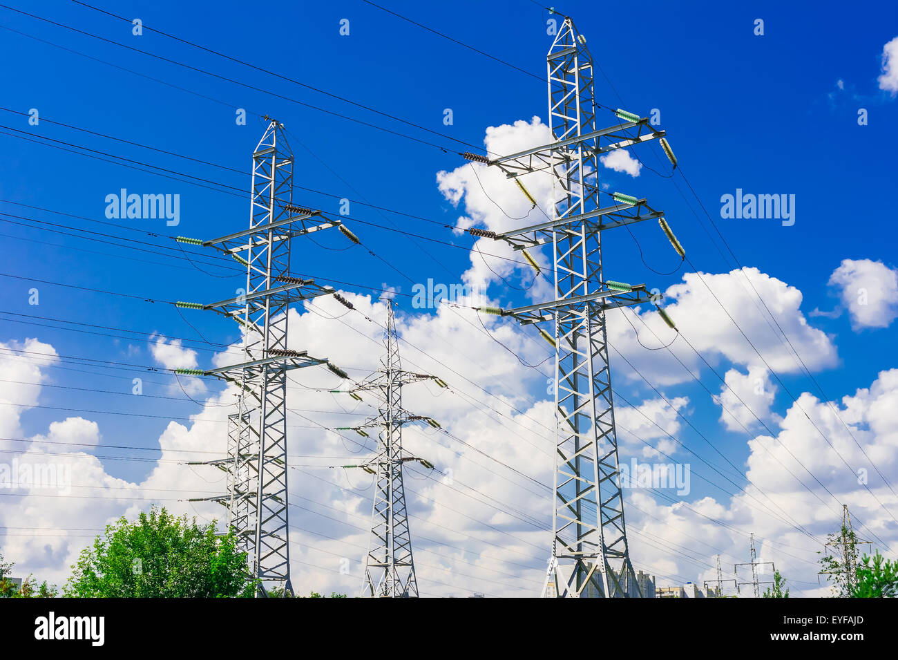 Power line towers on blue sky background Stock Photo - Alamy