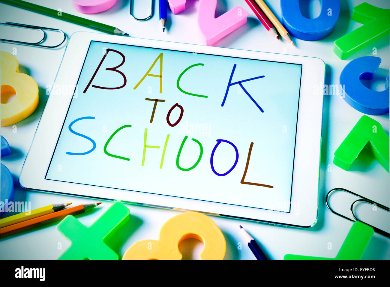 the sentence back to school handwritten in a tablet computer, placed on ...