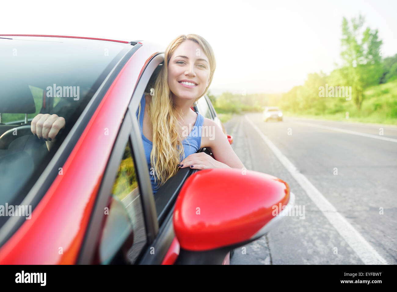 Woman in red car Stock Photo - Alamy