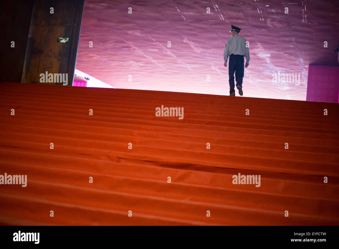 Security guard ascends stairs in a gallery, Songzhuang Art District, in ...