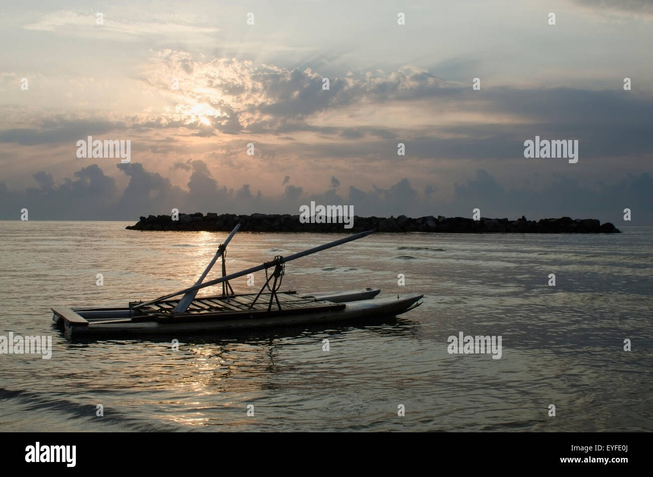 Italy, Marche, Floating raft on calm sea at sunrise with clouds and ...