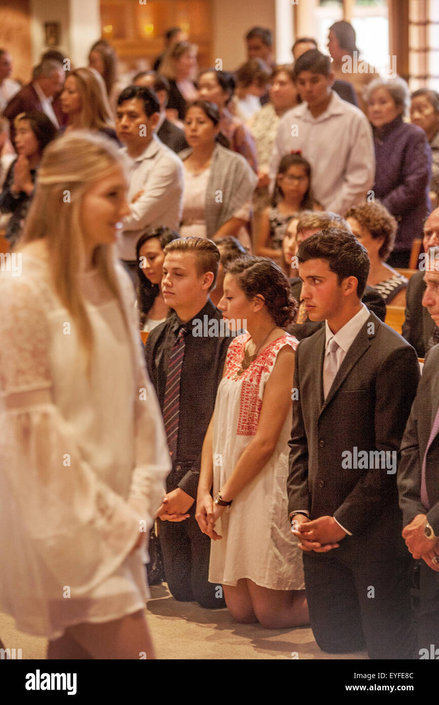 Formally dressed teen boys and girls pray on their knees during ...