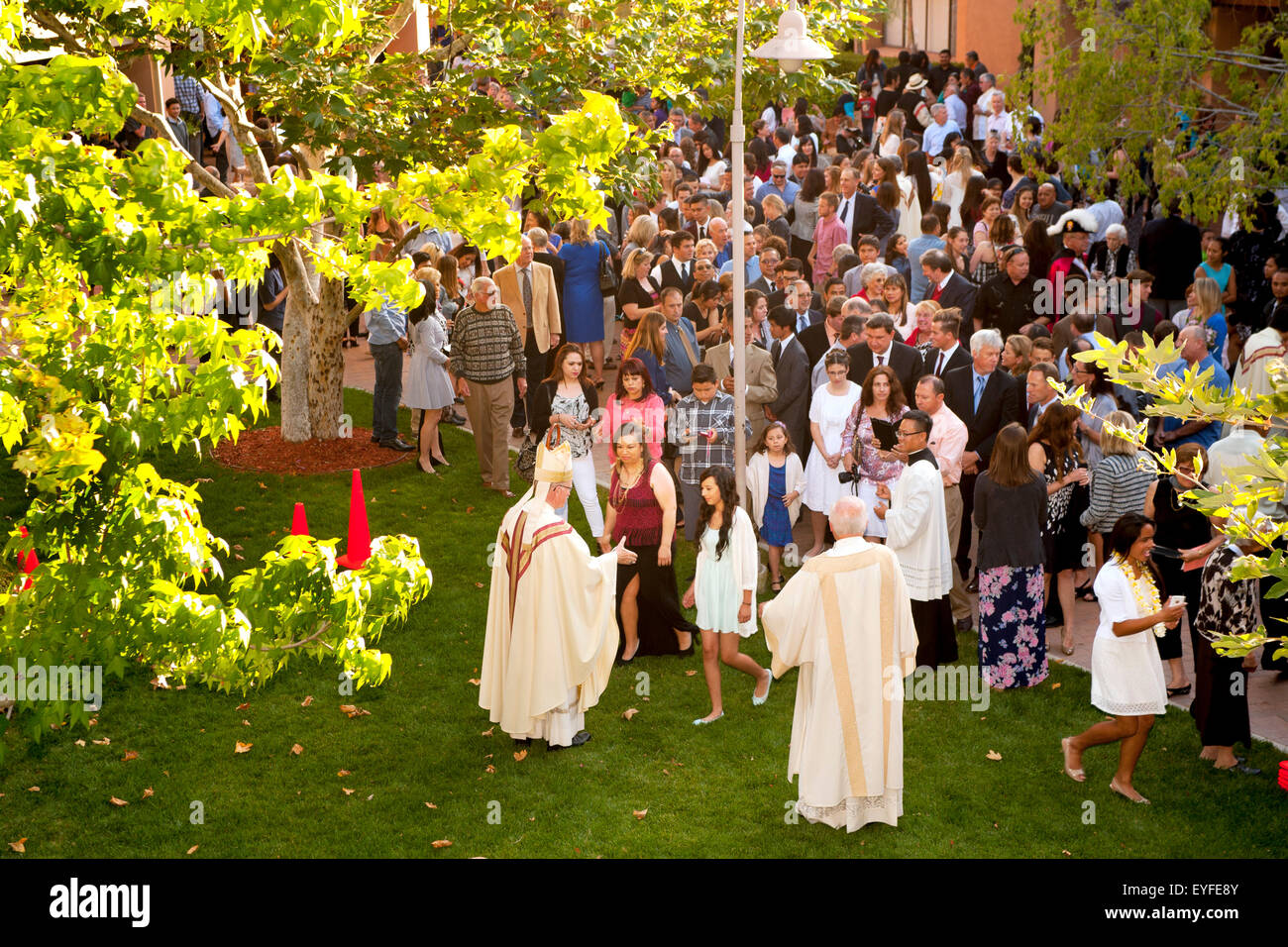 A bishop and priests pose with newly confirmed teenagers after ...