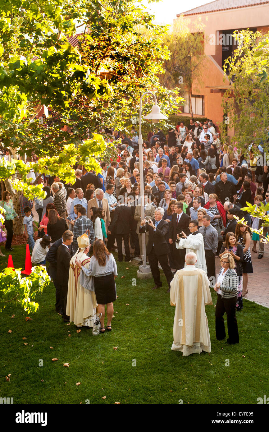 A bishop and priests pose with newly confirmed teenagers after ...