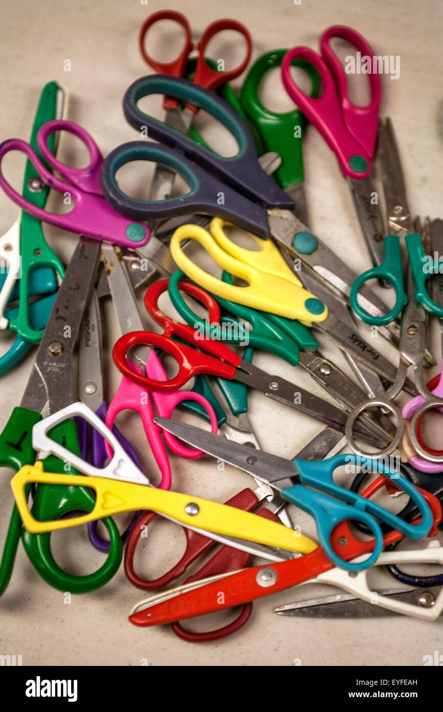 A colorful collection of scissors lies on a tabletop Stock Photo - Alamy