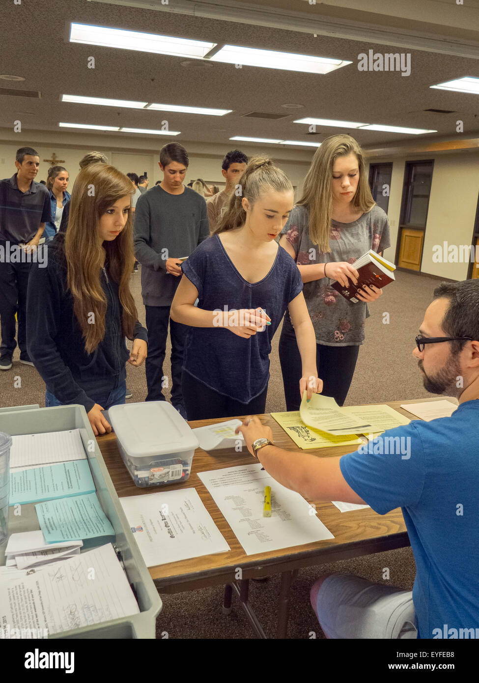 Teenagers collect handouts on deportment at confirmation exercises at a ...