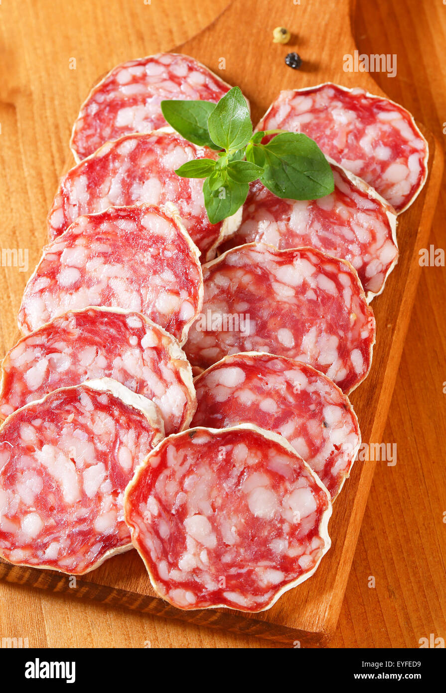 Sliced French Saucisson Sec on cutting board Stock Photo - Alamy