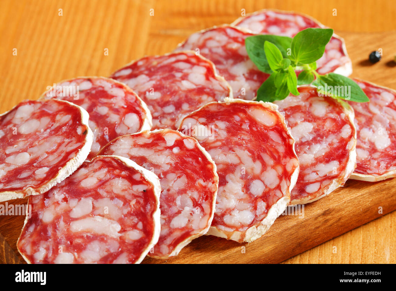 Sliced French Saucisson Sec on cutting board Stock Photo - Alamy