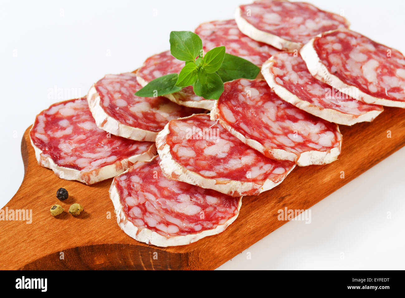 Sliced French Saucisson Sec on cutting board Stock Photo - Alamy