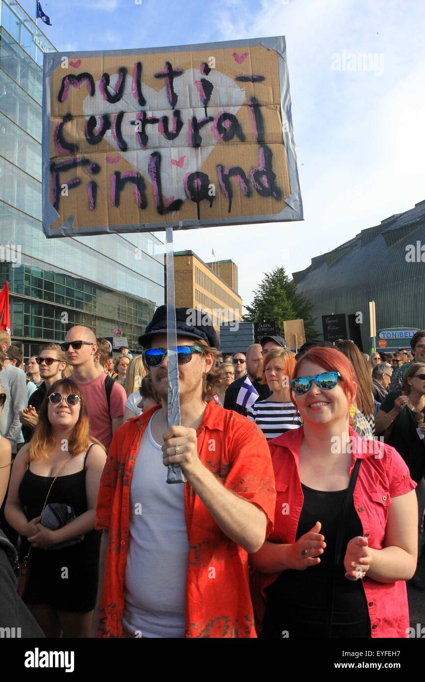 Helsinki. 28th July, 2015. Demonstrators hold a placard carrying the ...