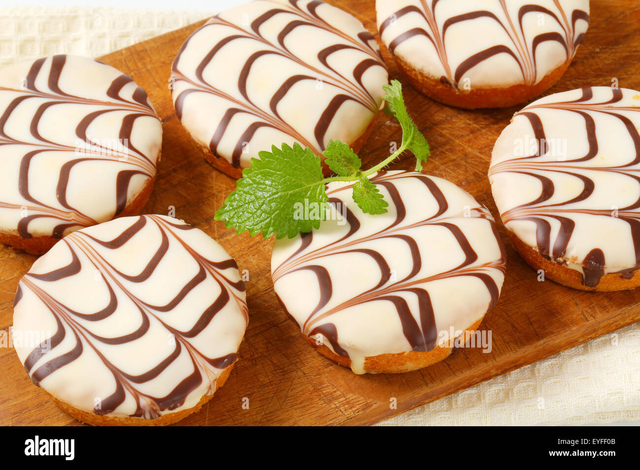 Mini cakes with white chocolate glaze Stock Photo - Alamy