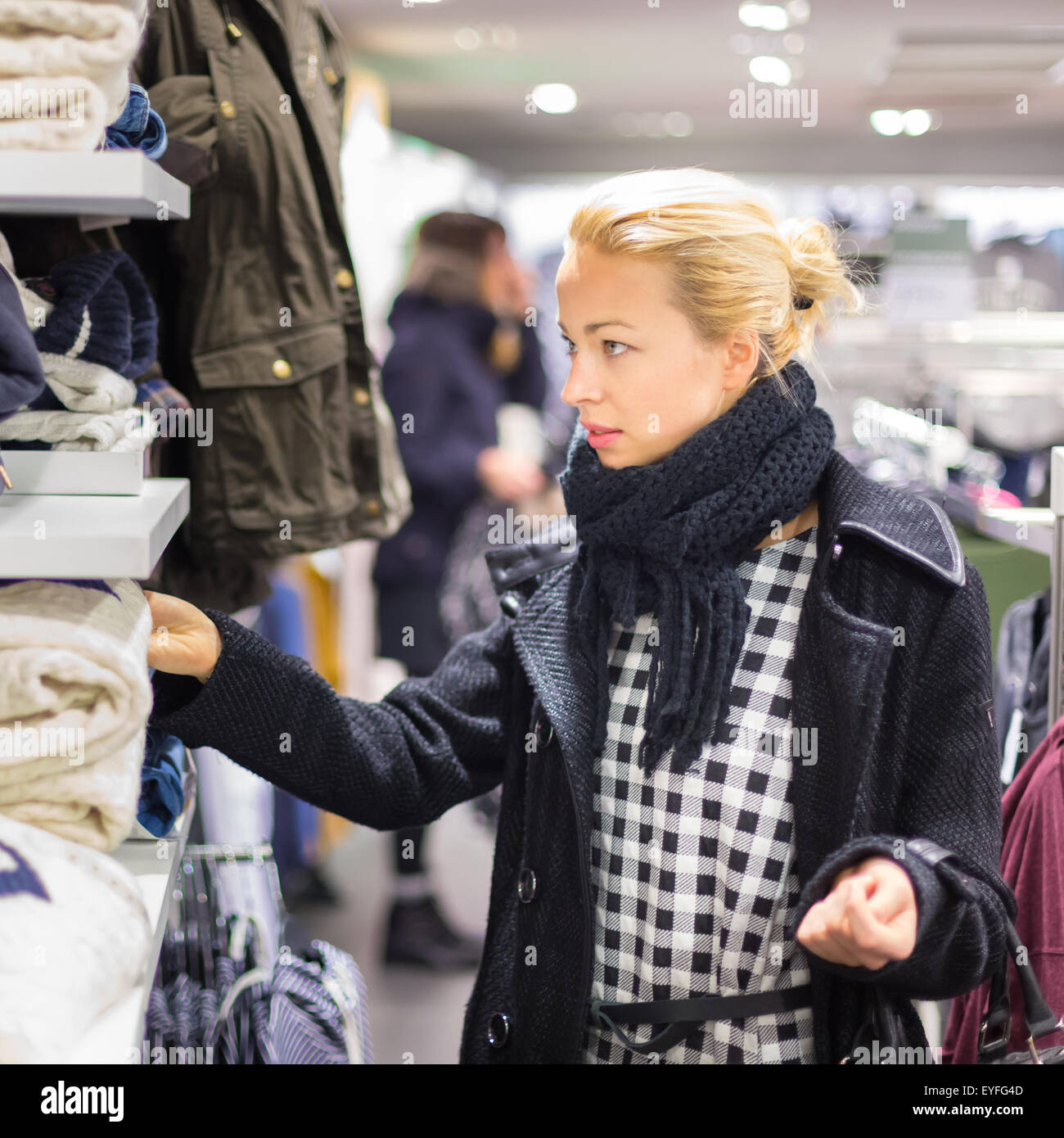 Beautiful woman shopping in clothing store Stock Photo - Alamy