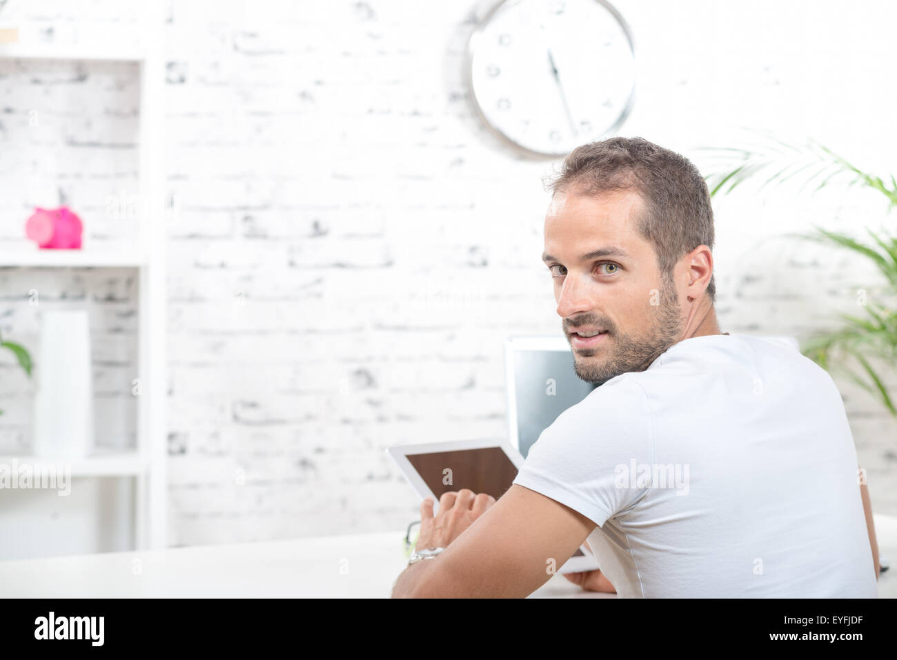 a young man looking at a digital tablet Stock Photo - Alamy