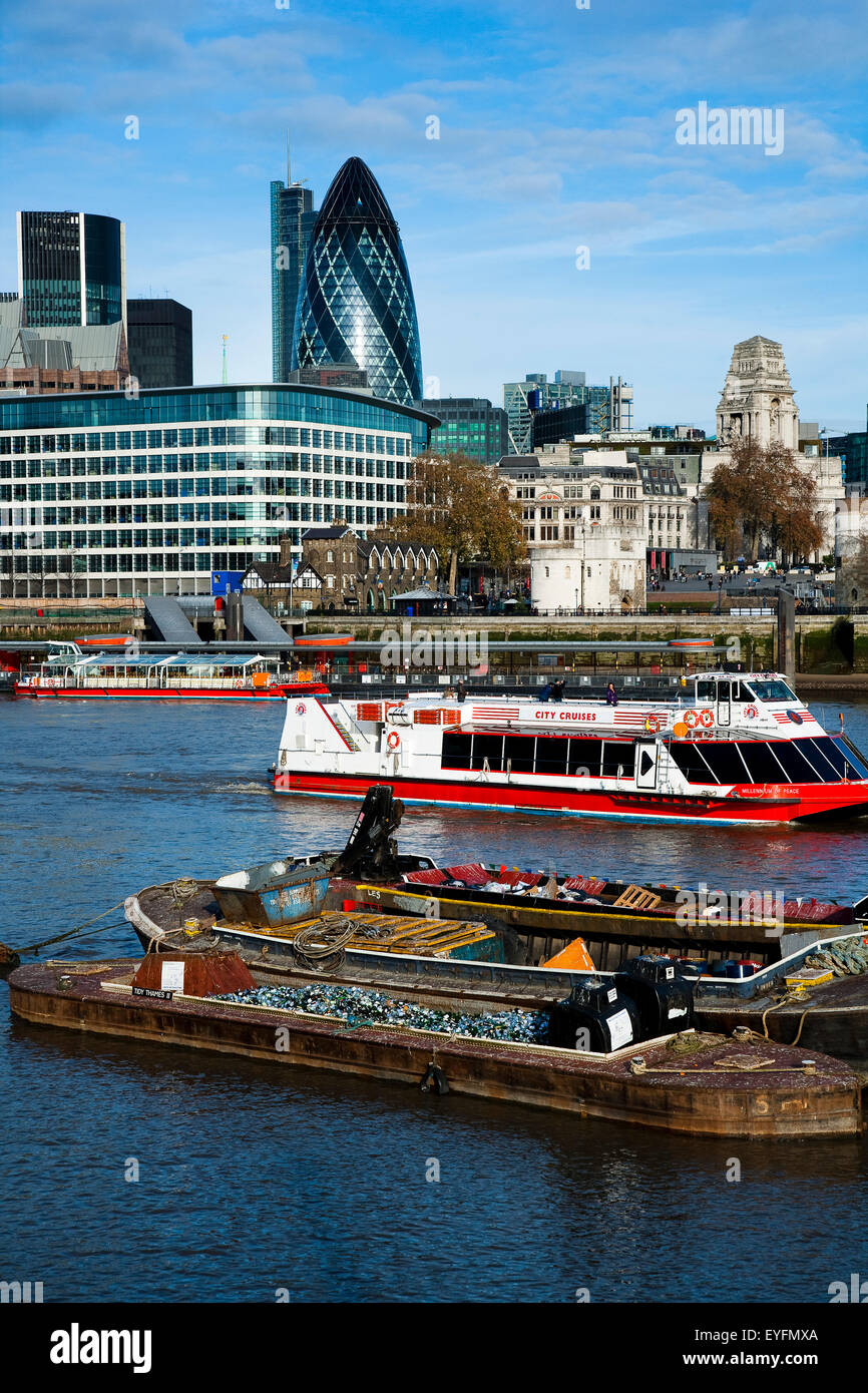 The Gherkin building dominates the skyline with tourists boats and ...