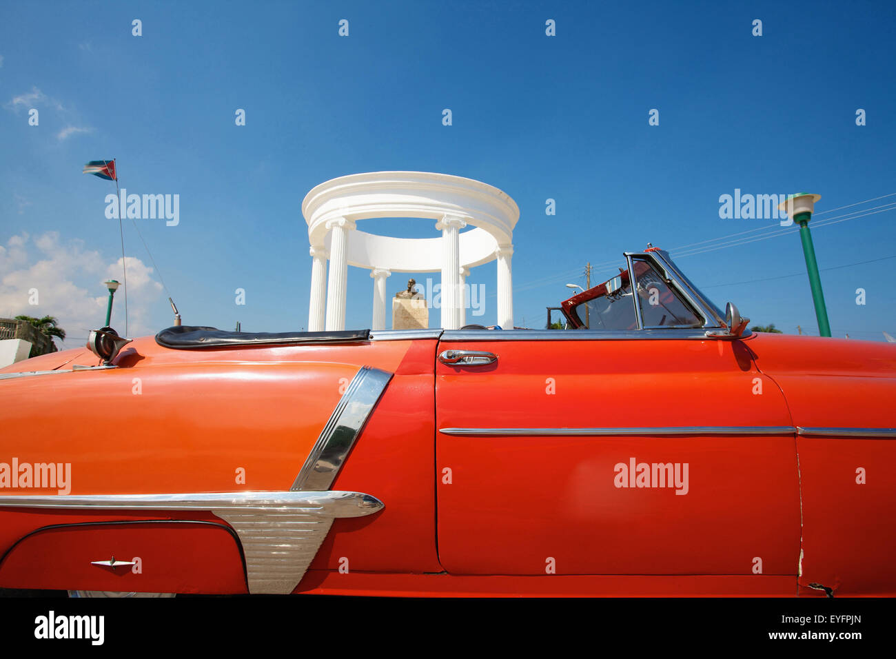Cuba, Side view of red vintage car with statue of Ernest Hemingway in ...
