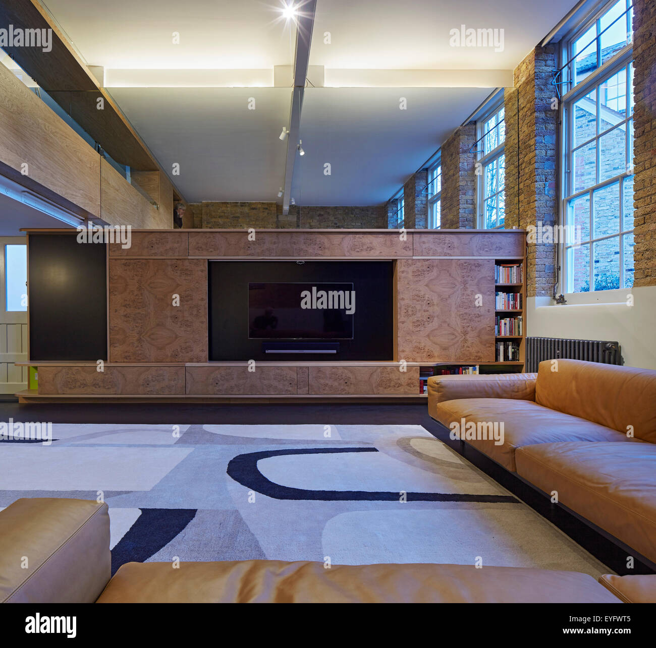 Double-height living area with library and sash windows. The Lyceé ...