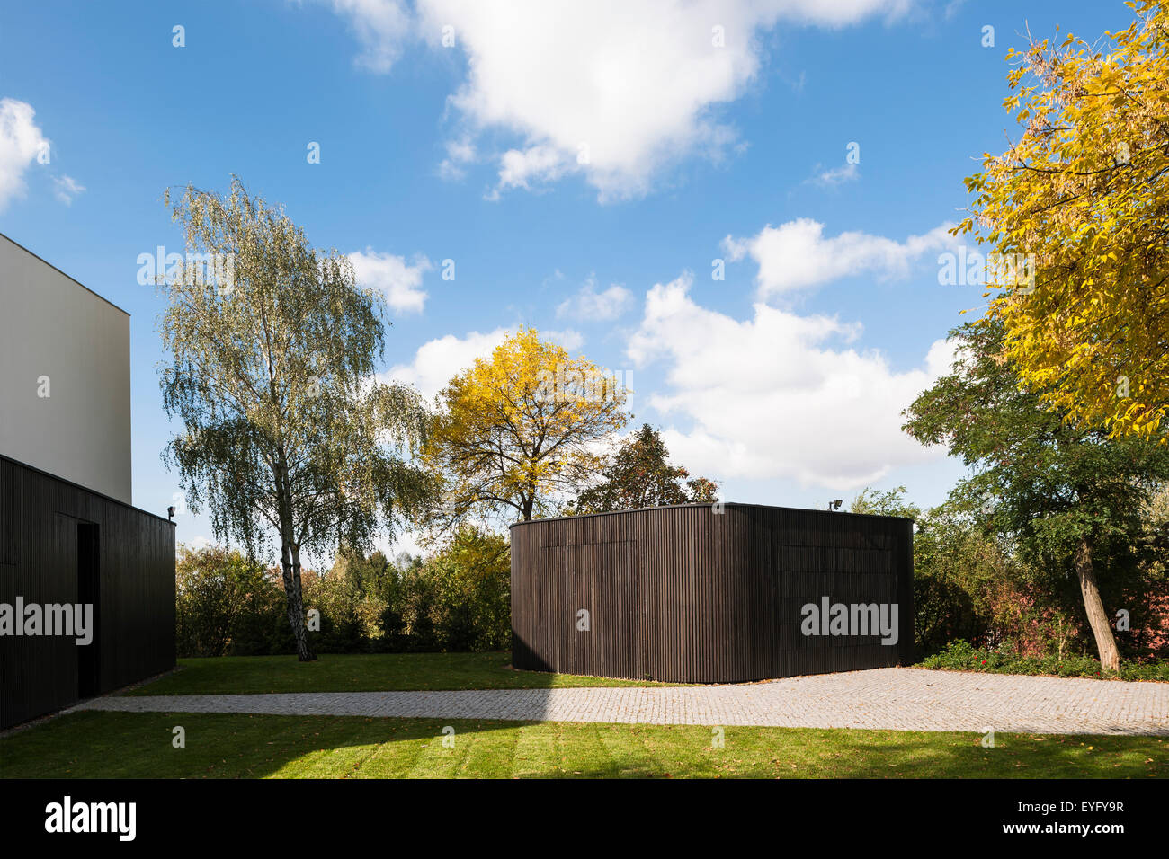 Approach with multi-functional garage and storage pavilion. Living ...