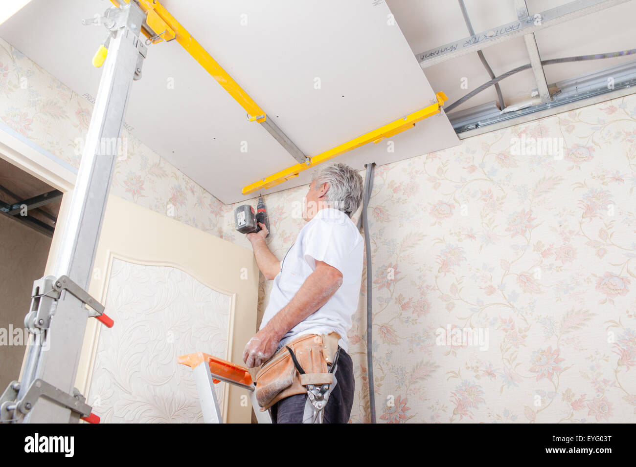 Mason drilling into a ceiling Stock Photo - Alamy