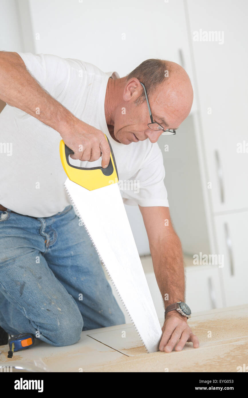 Carpenter using a hand saw Stock Photo - Alamy