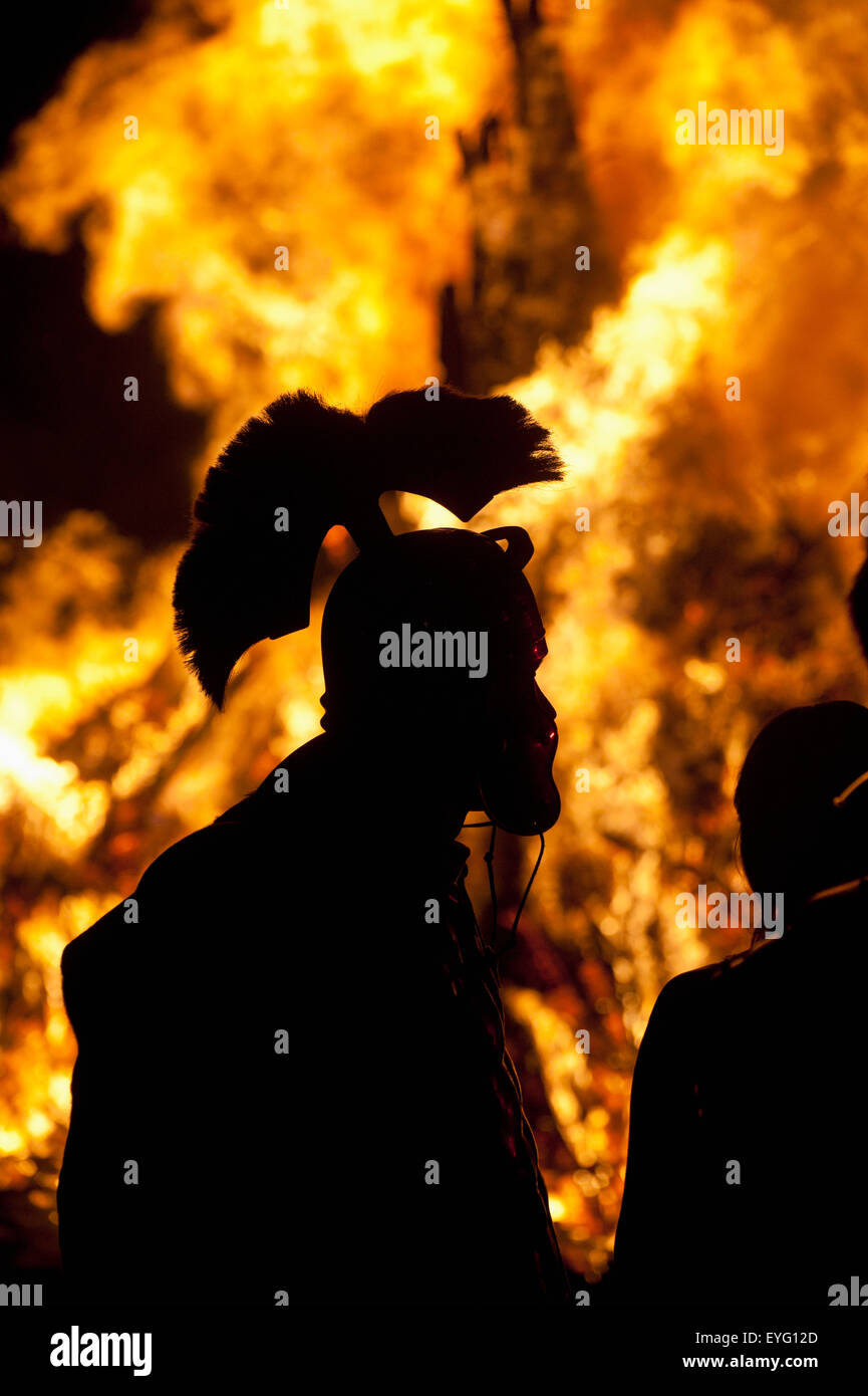 UK, England, Silhouette of Roman Gladiator in front of large bonfire at ...