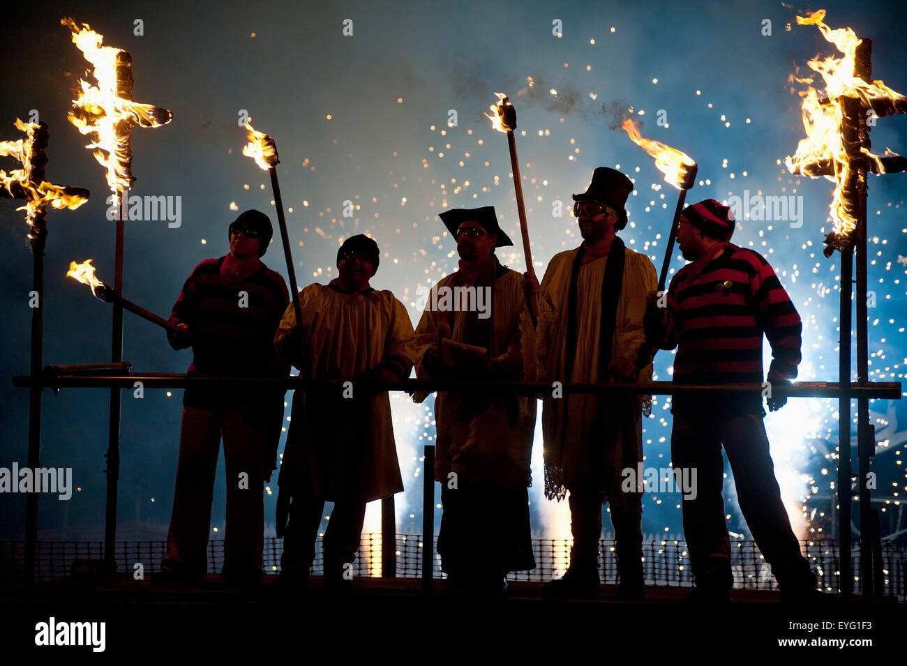 UK, England, People dressed as clergy on stand with fireworks behind ...