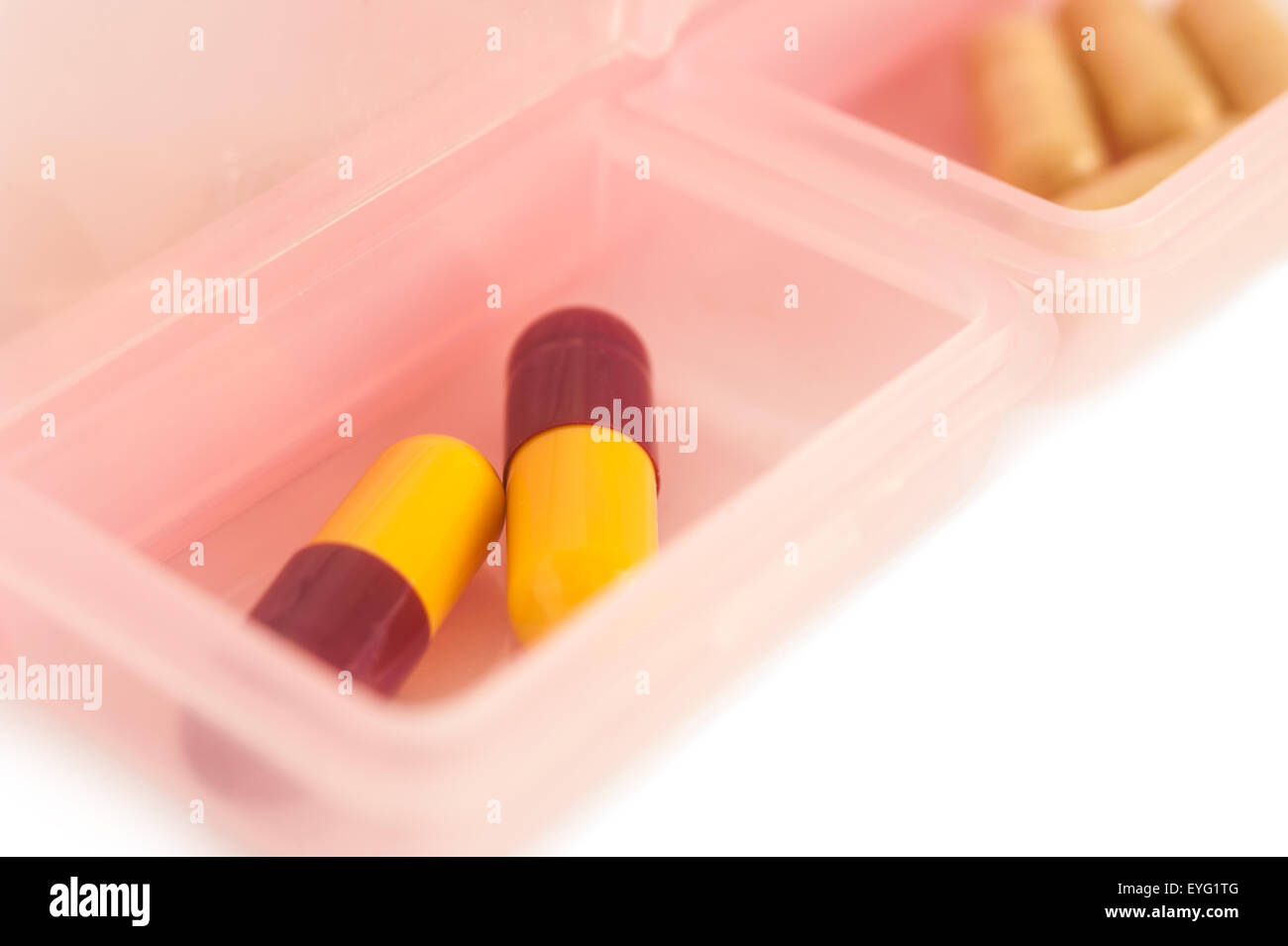 Medicine capsule in plate on white background Stock Photo - Alamy