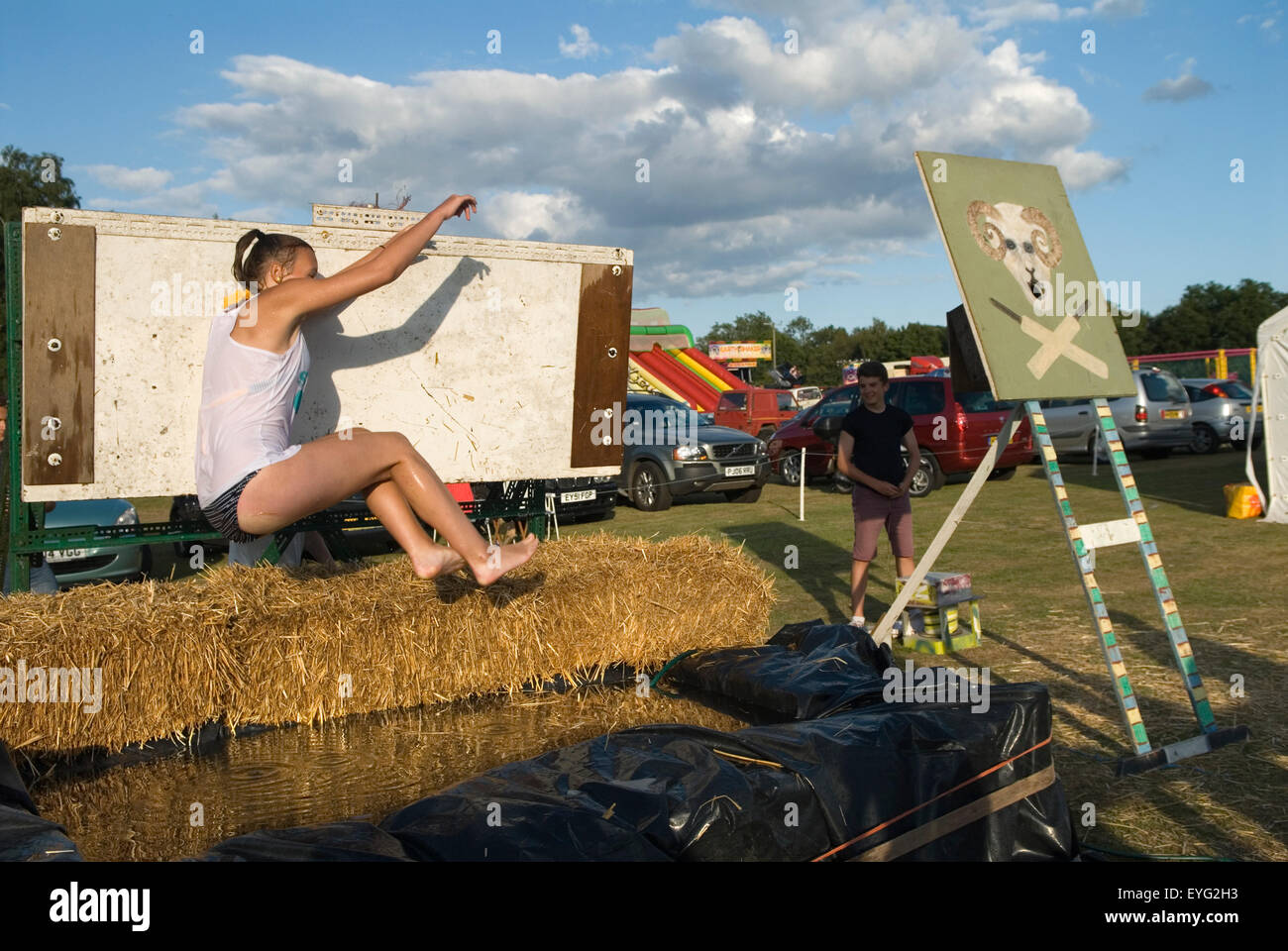 Dunking stool on platform, village fair young woman being dunked ...