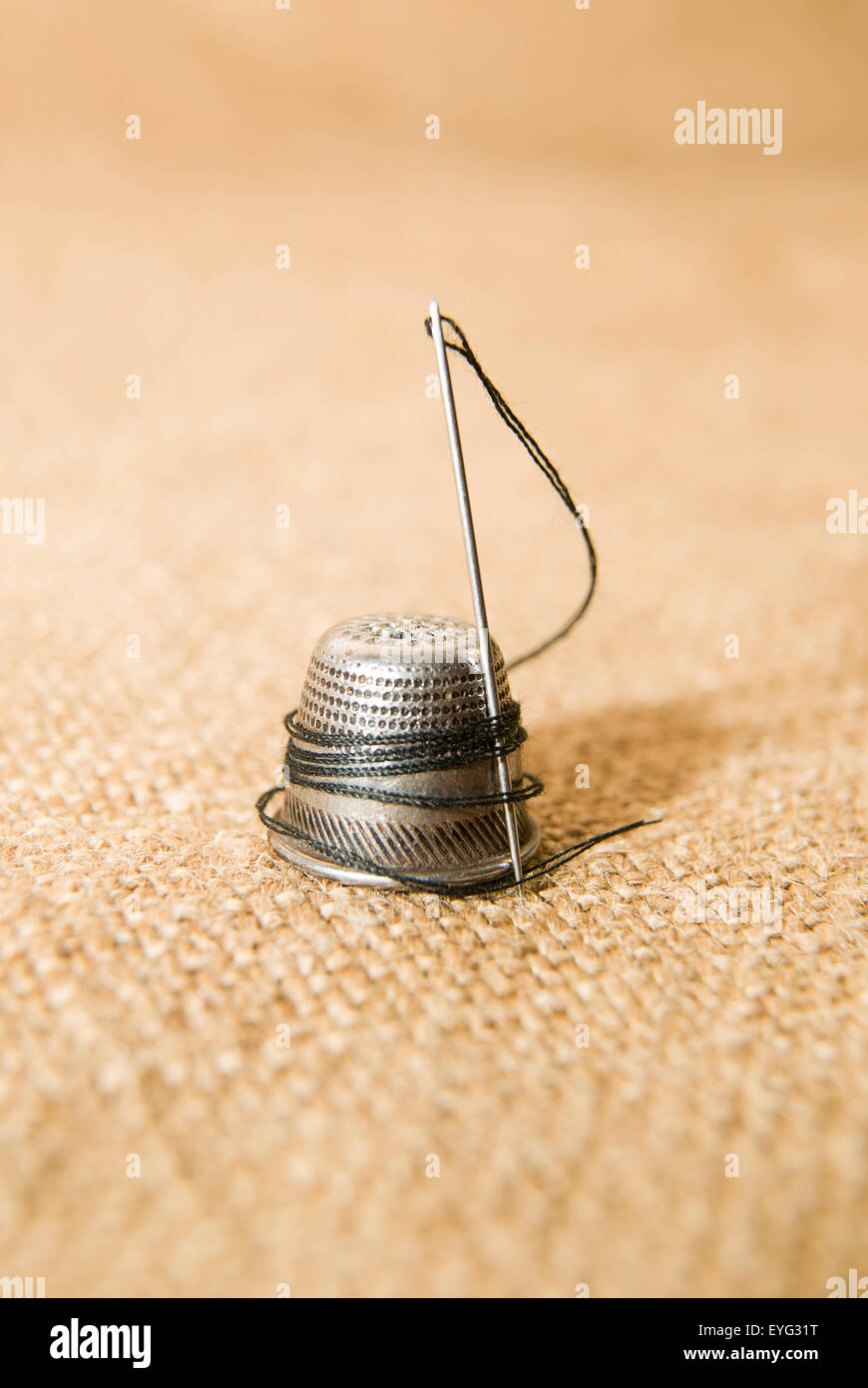 Sewing Needle and thimble on the old cloth Stock Photo - Alamy