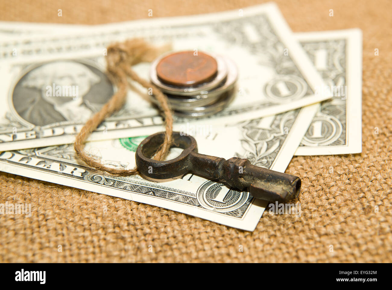 Dollars banknotes, coins and key on an old cloth Stock Photo - Alamy