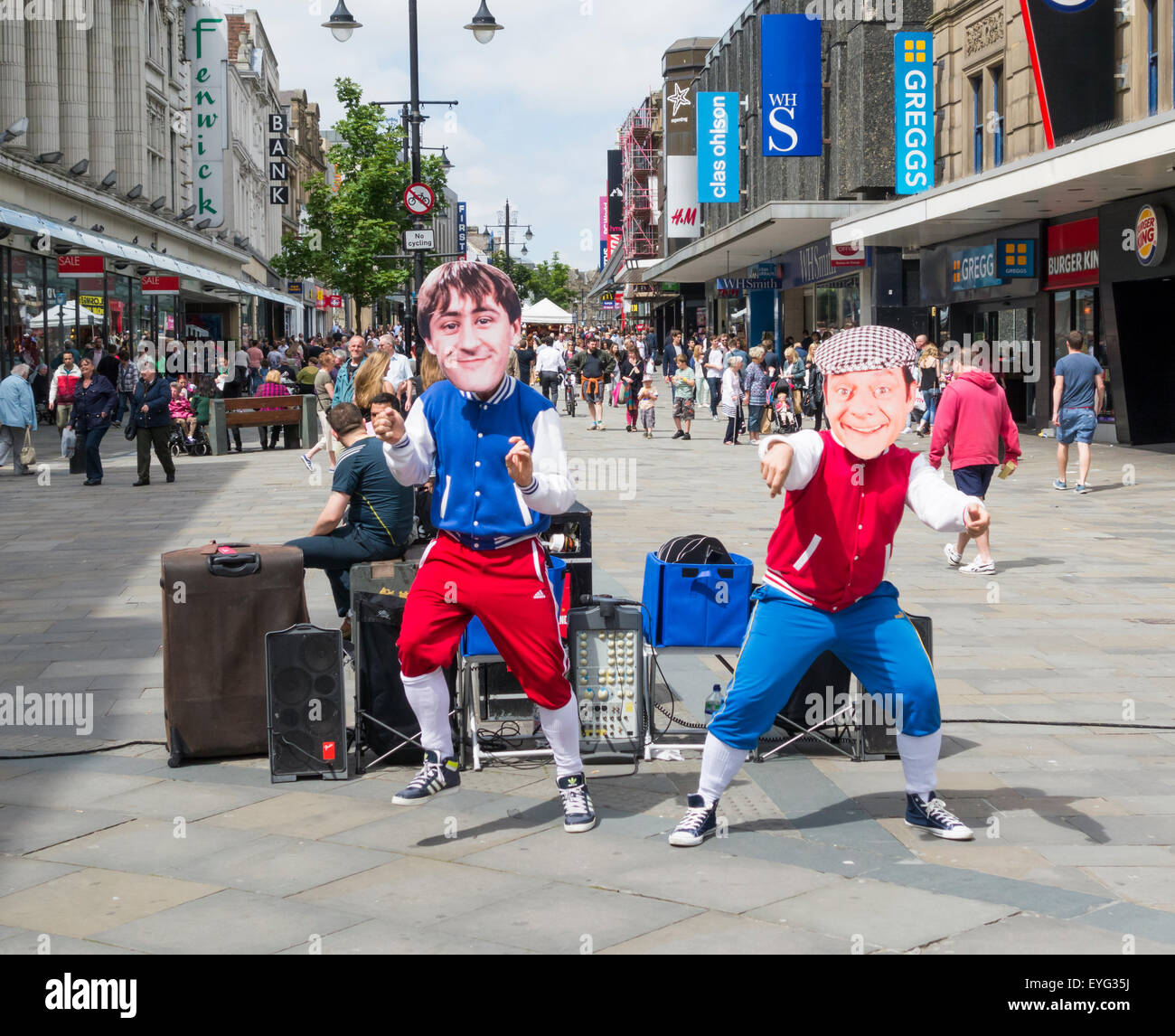 Buskers wearing masks of famous people/celebrites performing on ...