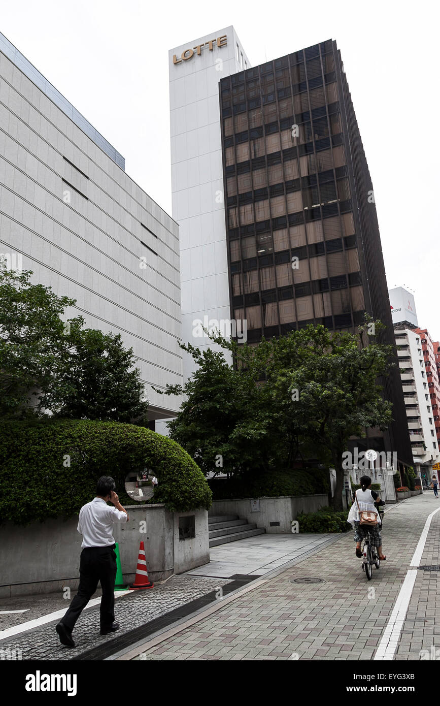 Pedestrians walk past the LOTTE Japan headquarters in Shinjuku on July ...