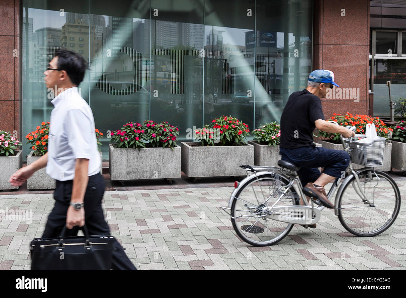 Pedestrians walk past the LOTTE Japan headquarters in Shinjuku on July ...
