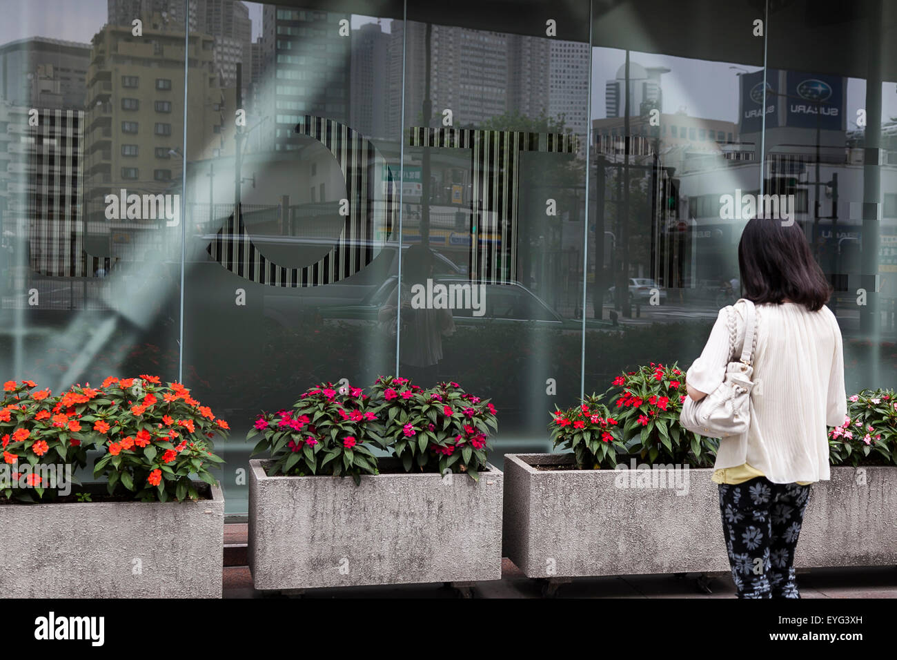 A pedestrian stands in front of the LOTTE Japan headquarters in ...