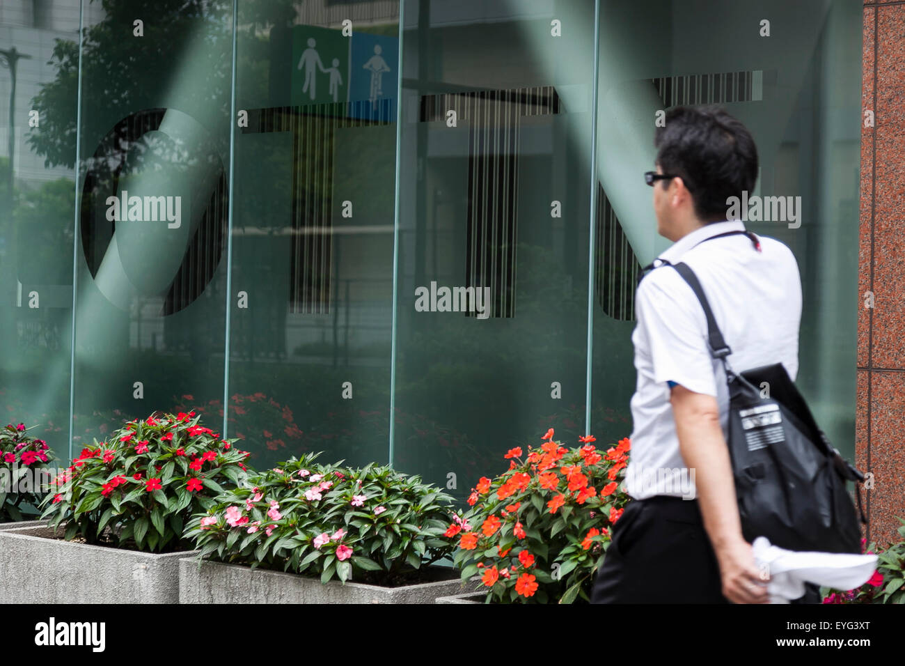A pedestrian walks past the LOTTE Japan headquarters in Shinjuku on ...